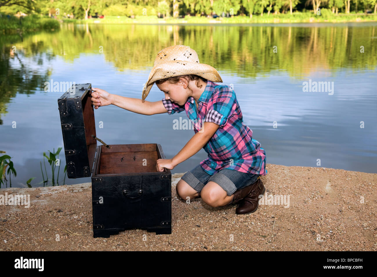 What's there? - Little girl by the lake Stock Photo - Alamy