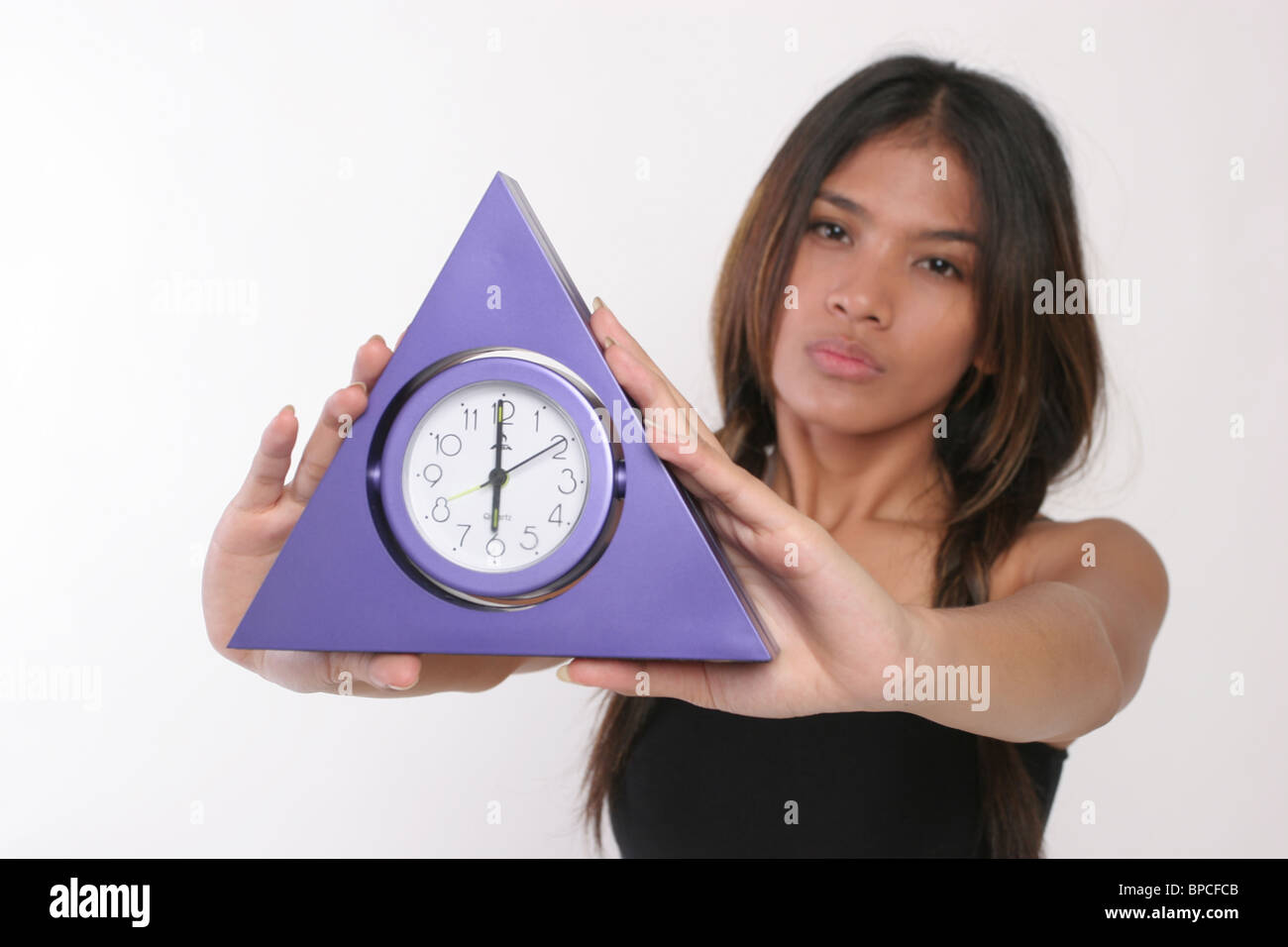 girl show triangle clock Stock Photo - Alamy