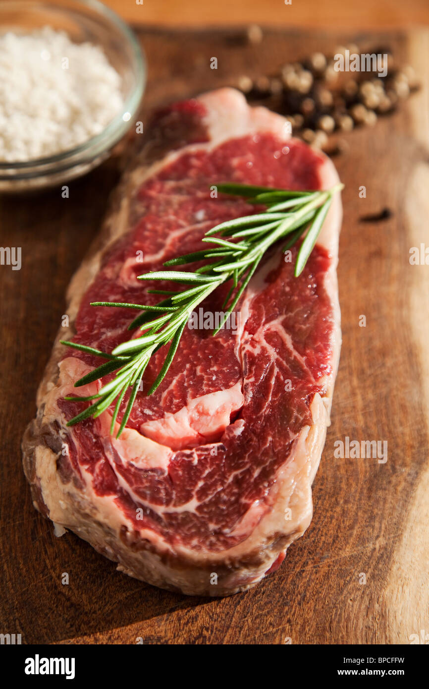 Uncooked meat with rosemary Stock Photo - Alamy