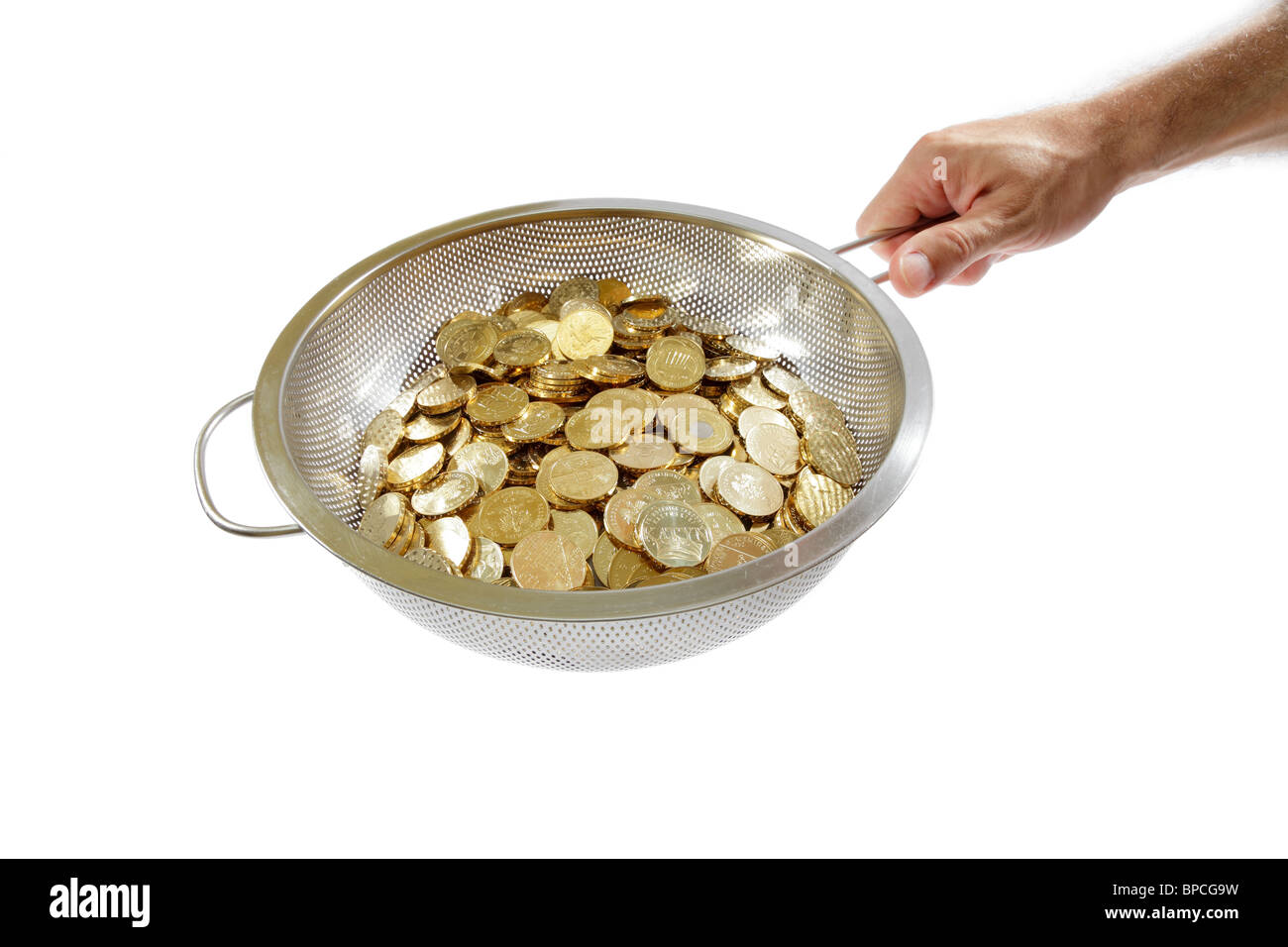 Gold coins in colander - isolated on white background Stock Photo - Alamy