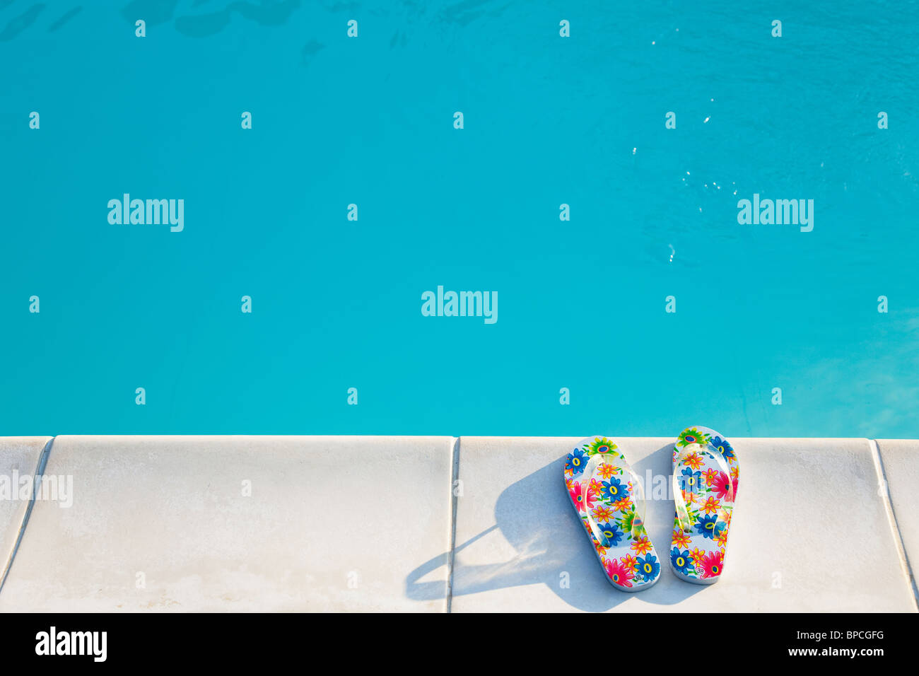 flip-flop near swimming-pool in morning sun Stock Photo - Alamy