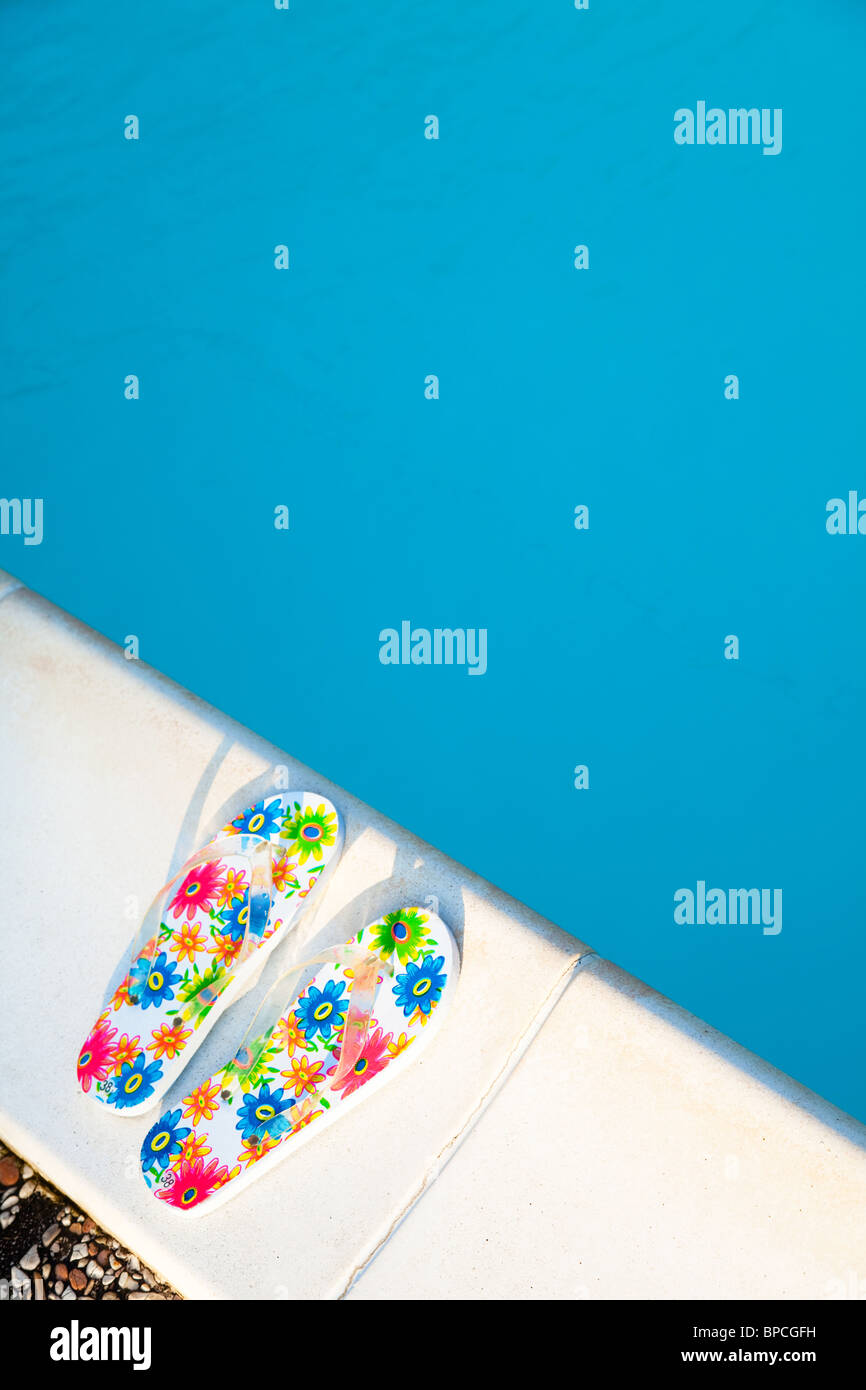 flip-flop near swimming-pool in morning sun Stock Photo - Alamy