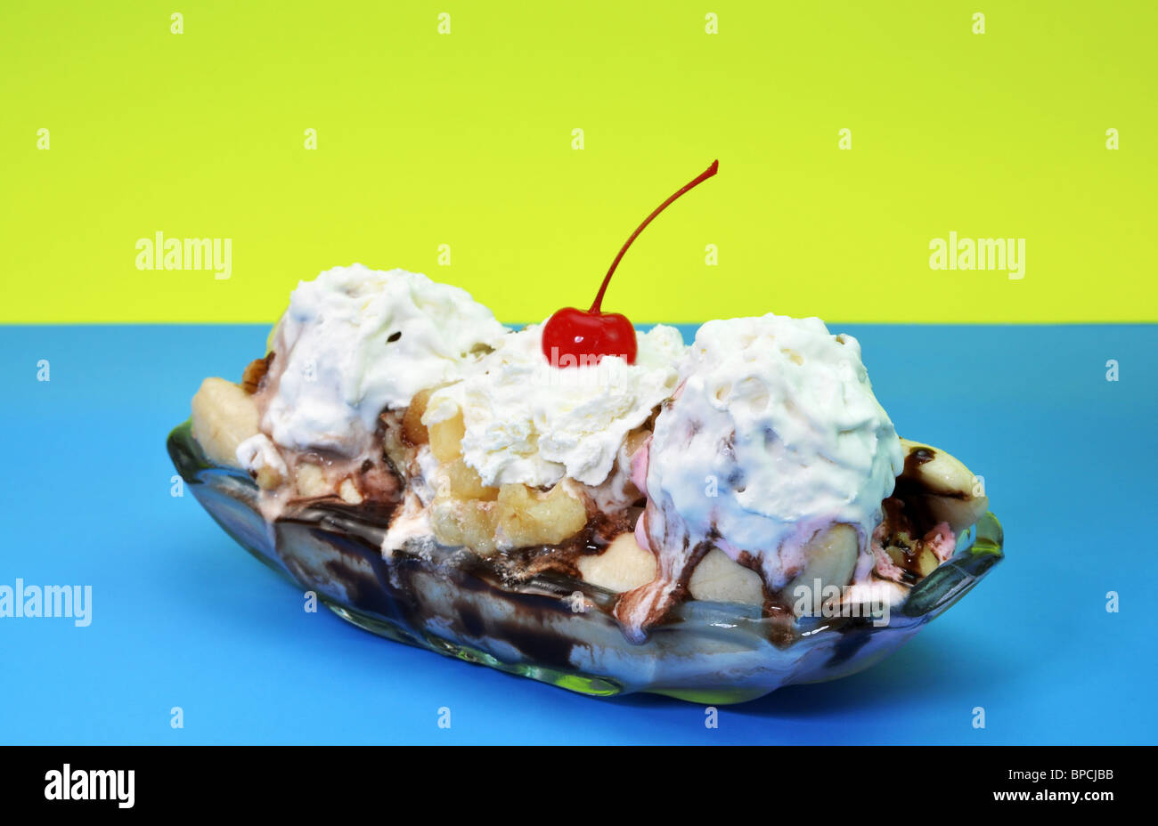 Banana split isolated on blue and yellow background Stock Photo - Alamy