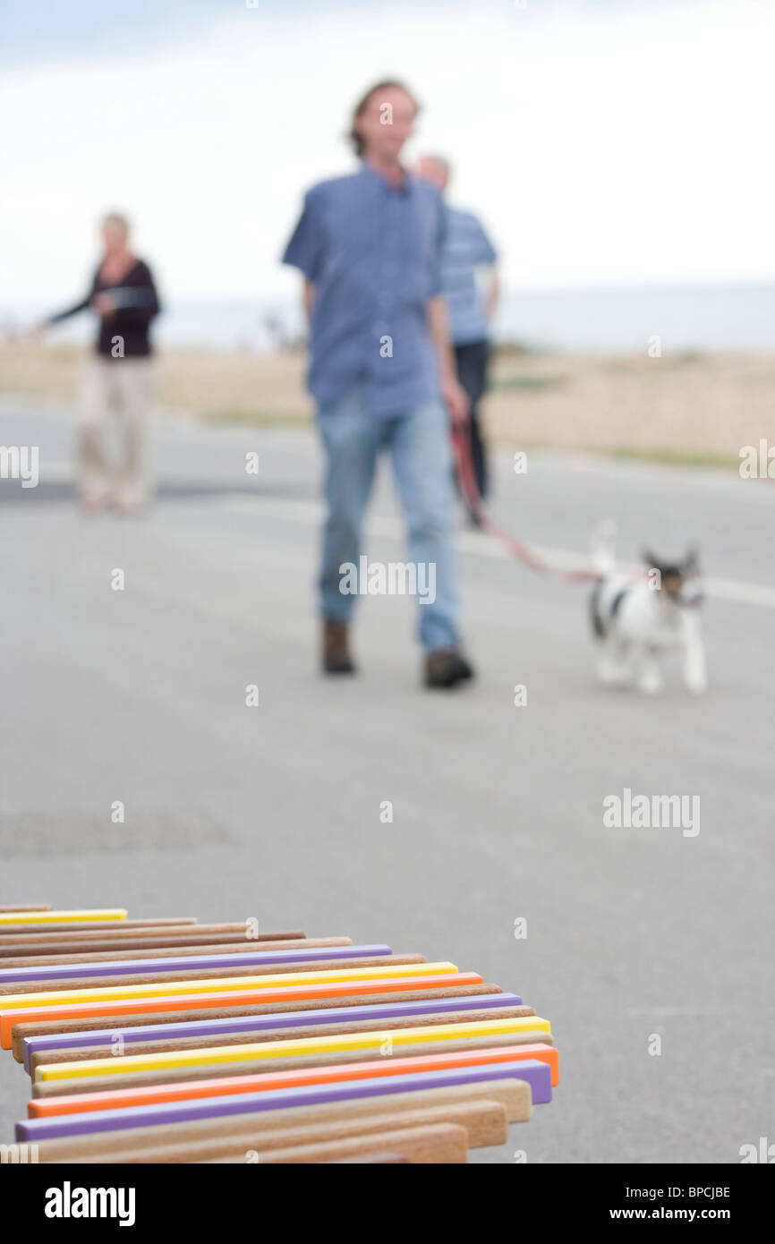 People walk past a colorful section of the Long Bench in Littlehampton ...