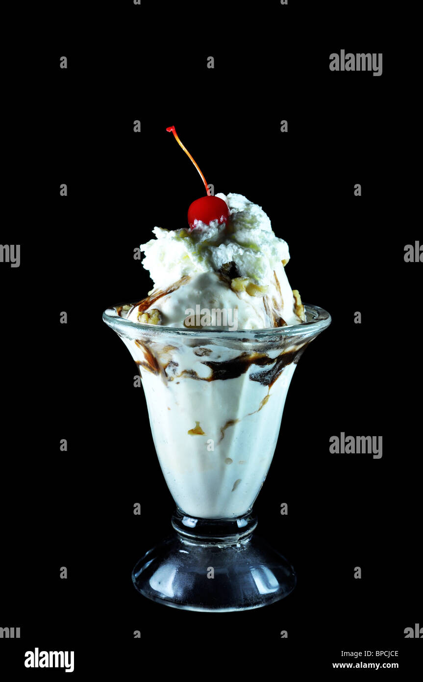 Chocolate fudge sundae isolated on black background Stock Photo - Alamy