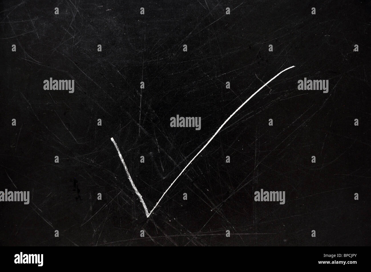 Check mark on black chalkboard with copy space Stock Photo - Alamy