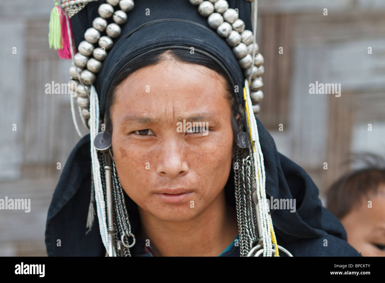 Akha woman with child on her back, Phongsaly, Laos Stock Photo - Alamy