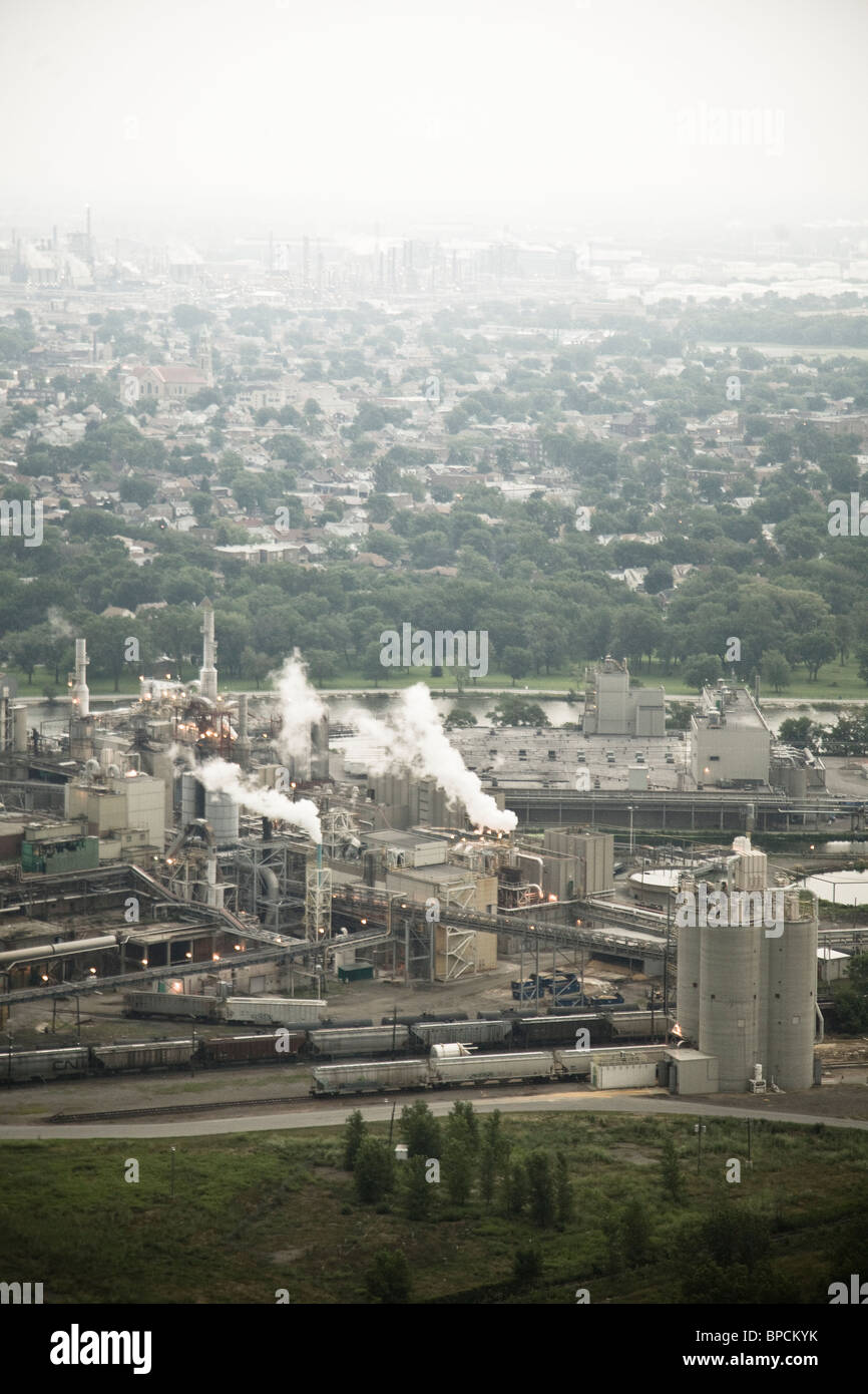 Aerial image of smoke coming out of a factory with trains and a smog ...