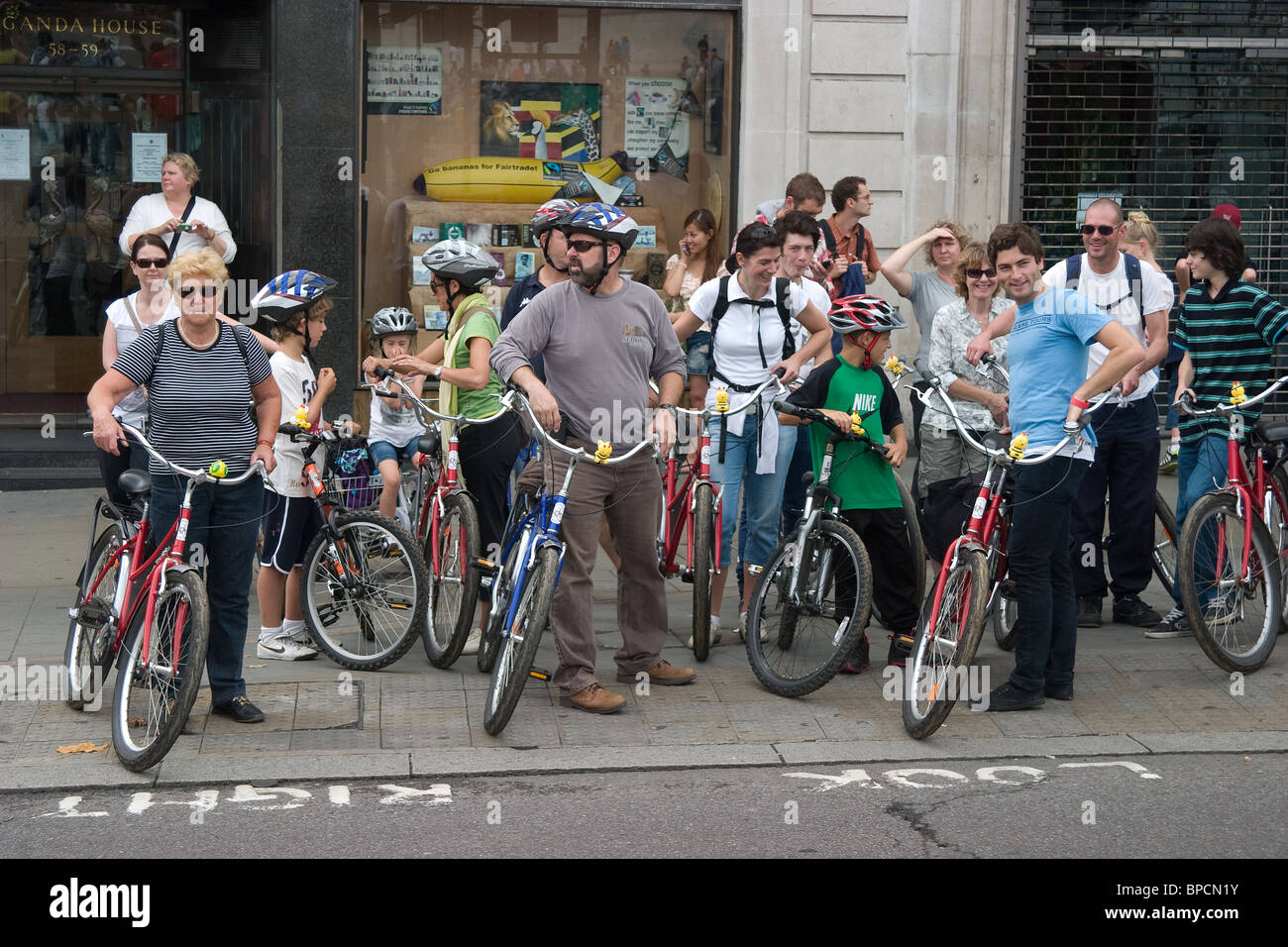 cyclists wait road crossing group summer safety Stock Photo - Alamy