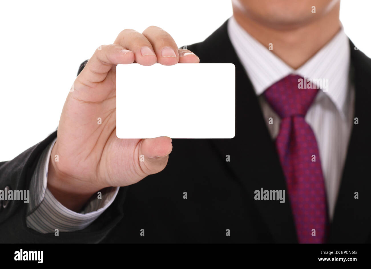 An Asian businessman displaying a blank card. Clipping path included ...