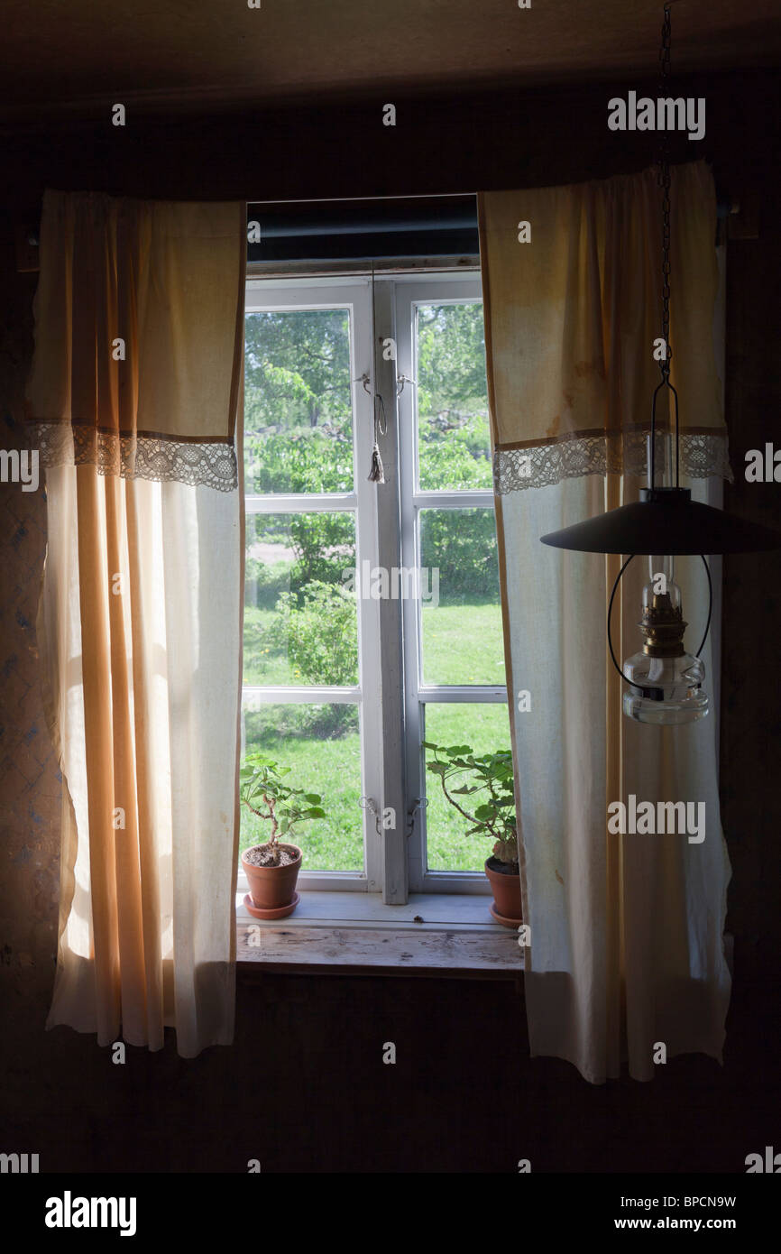 Window from the inside of an old cottage with an oil lamp Stock Photo ...