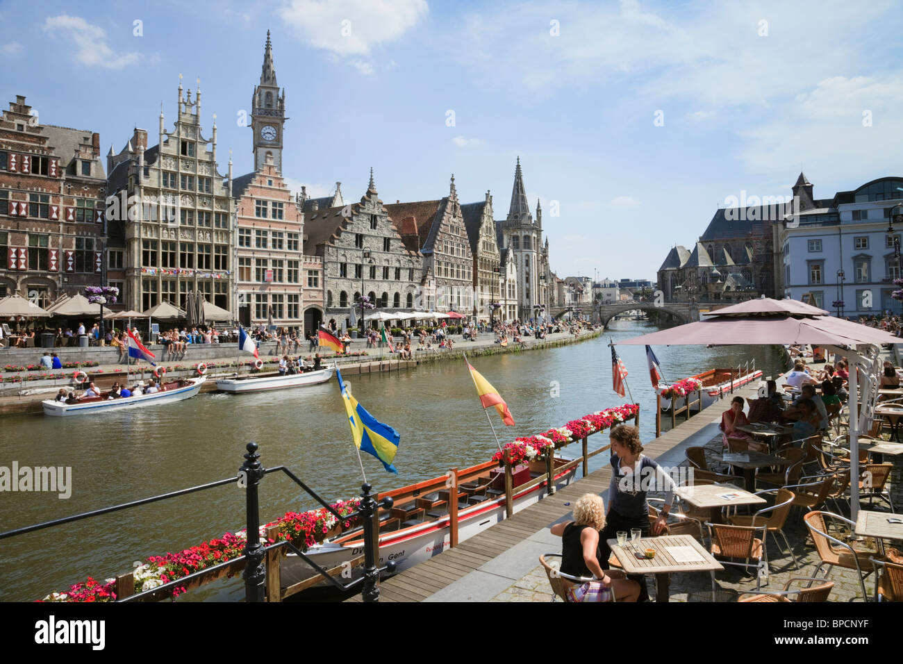 Riverside café and view across River Leie to medieval guild houses on ...
