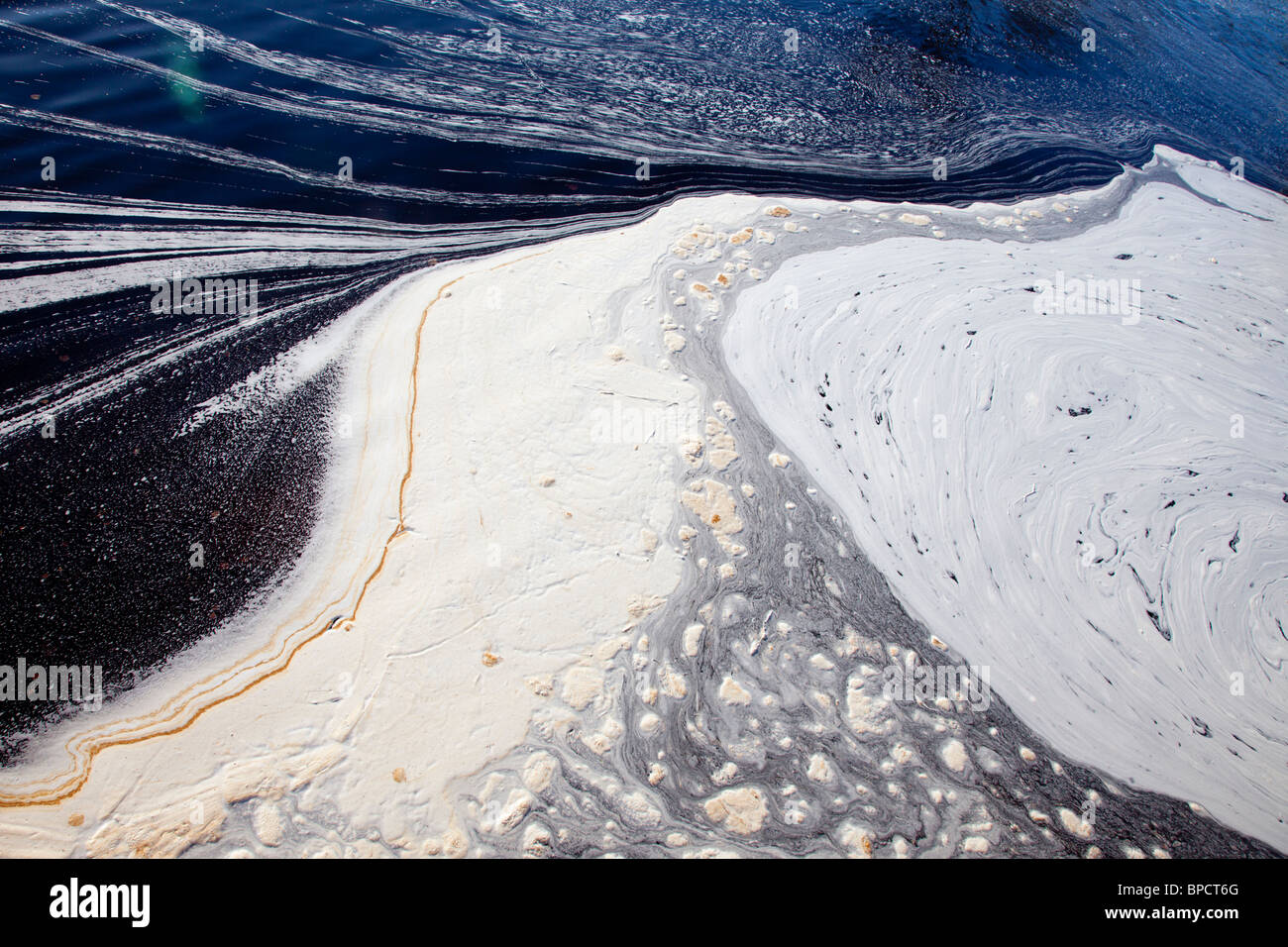 Layer of waste floating on water surface Stock Photo - Alamy