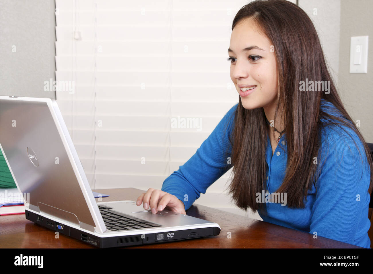 Teen girl doing homework Stock Photo - Alamy