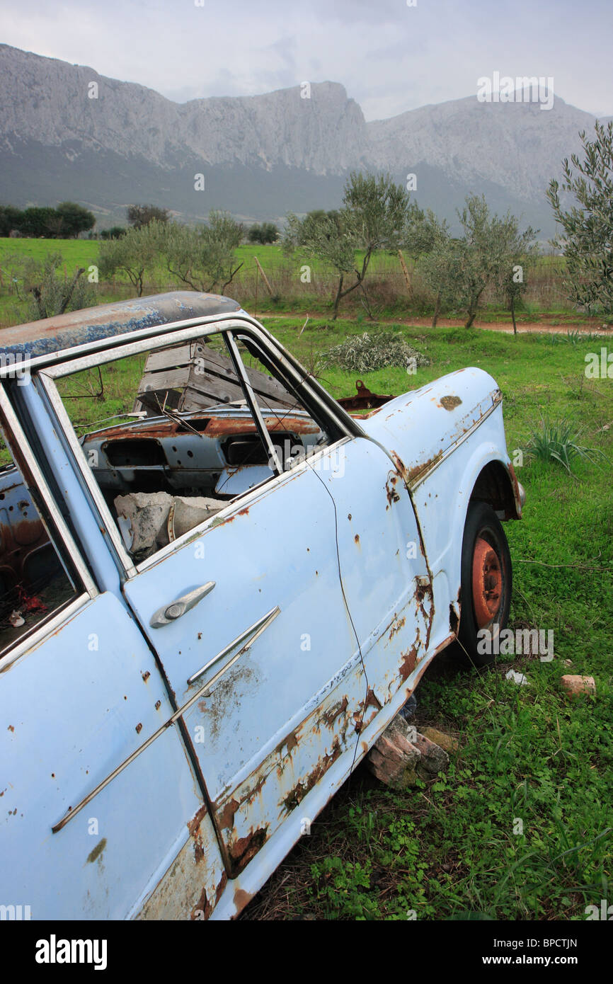 A broken, rusty car on the roadside, Sardinia, Italy Stock Photo - Alamy
