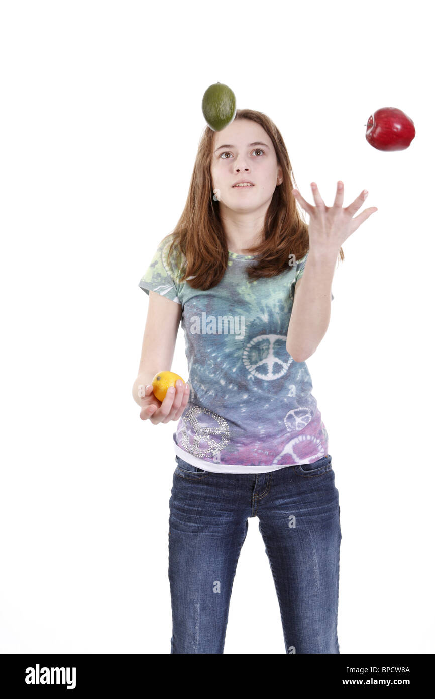 Teen girl juggling fruit Stock Photo - Alamy