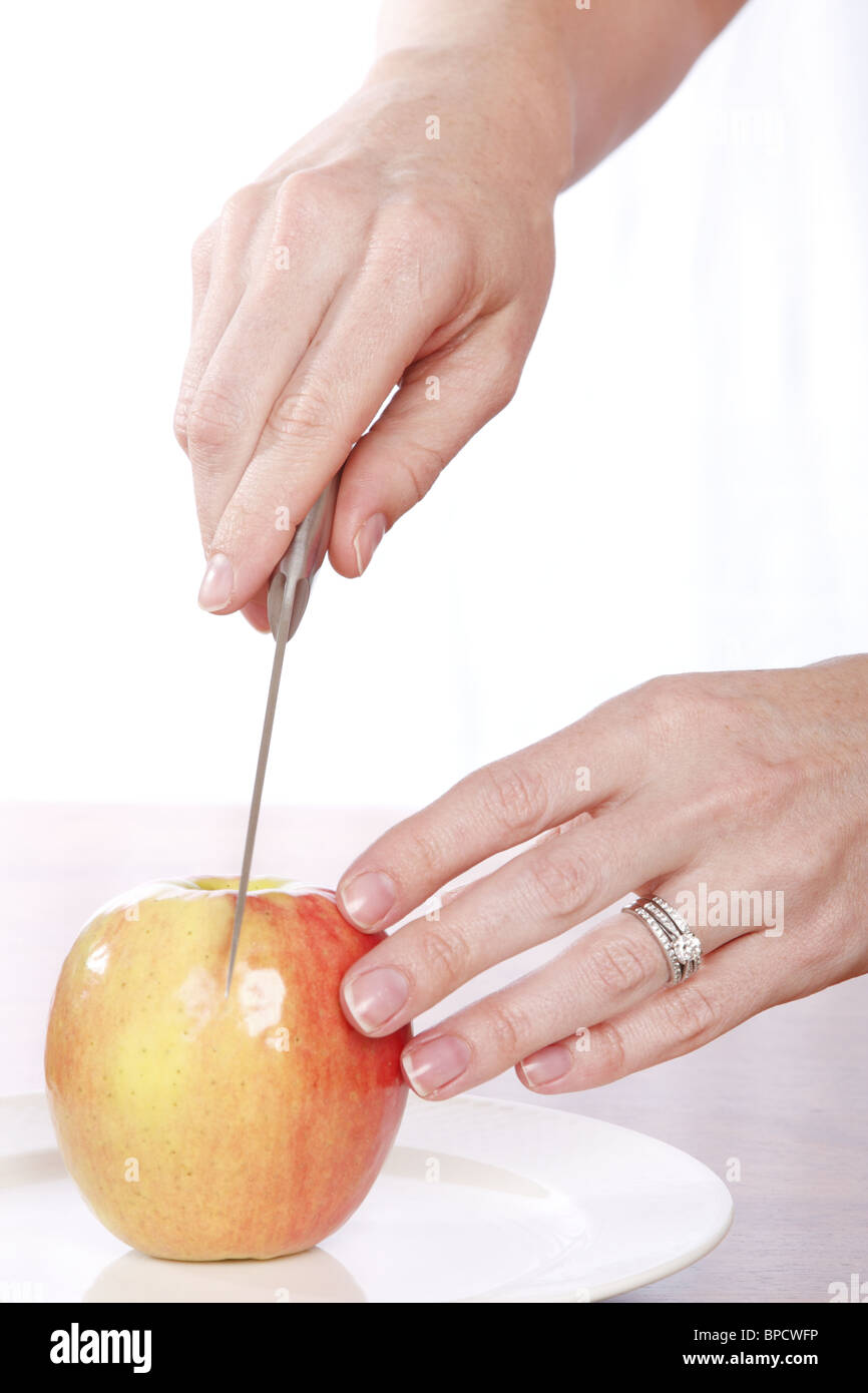 Hands slicing an apple Stock Photo - Alamy