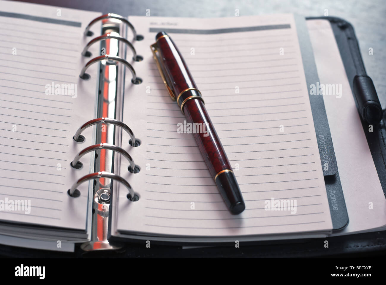Open pen on note pad before meeting Stock Photo - Alamy