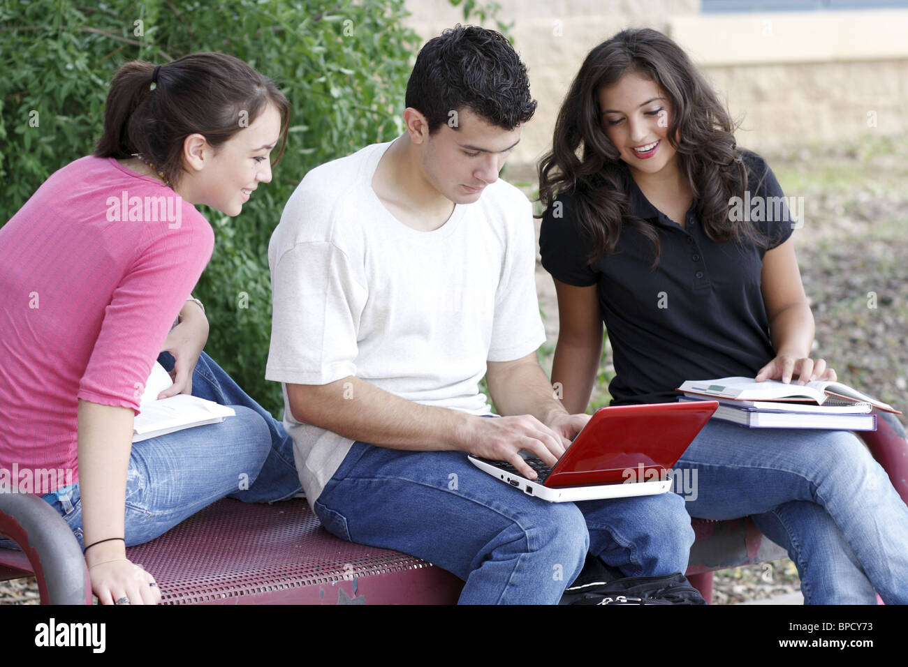 students studying on a bench at school Stock Photo - Alamy