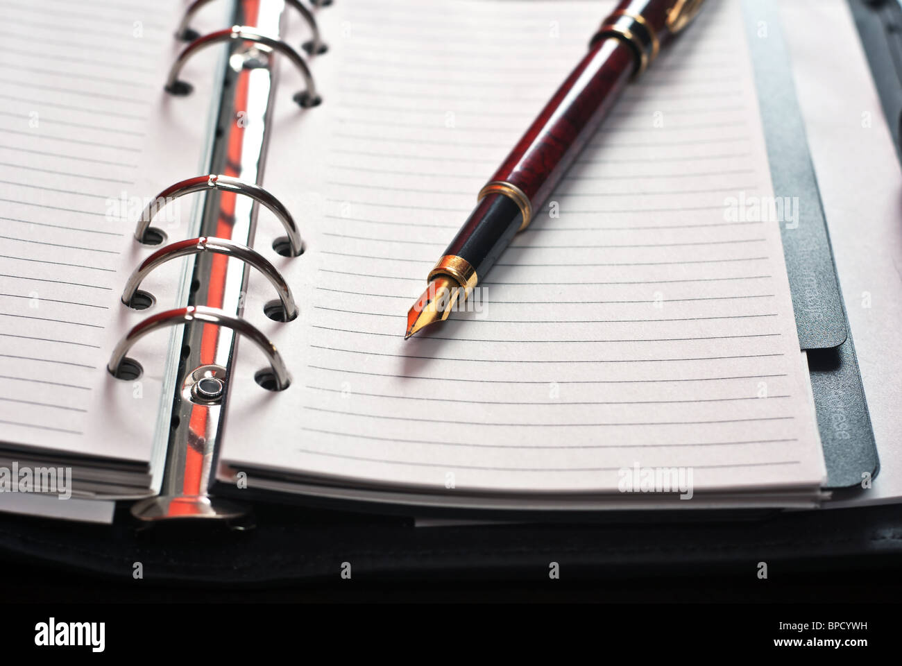 Open pen on note pad before meeting Stock Photo - Alamy