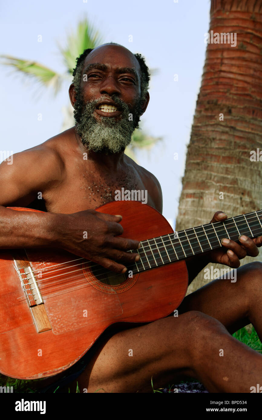 OLD BLACK MEN PLAYING GUITAR ON A TROPICAL ISLAND Stock Photo - Alamy
