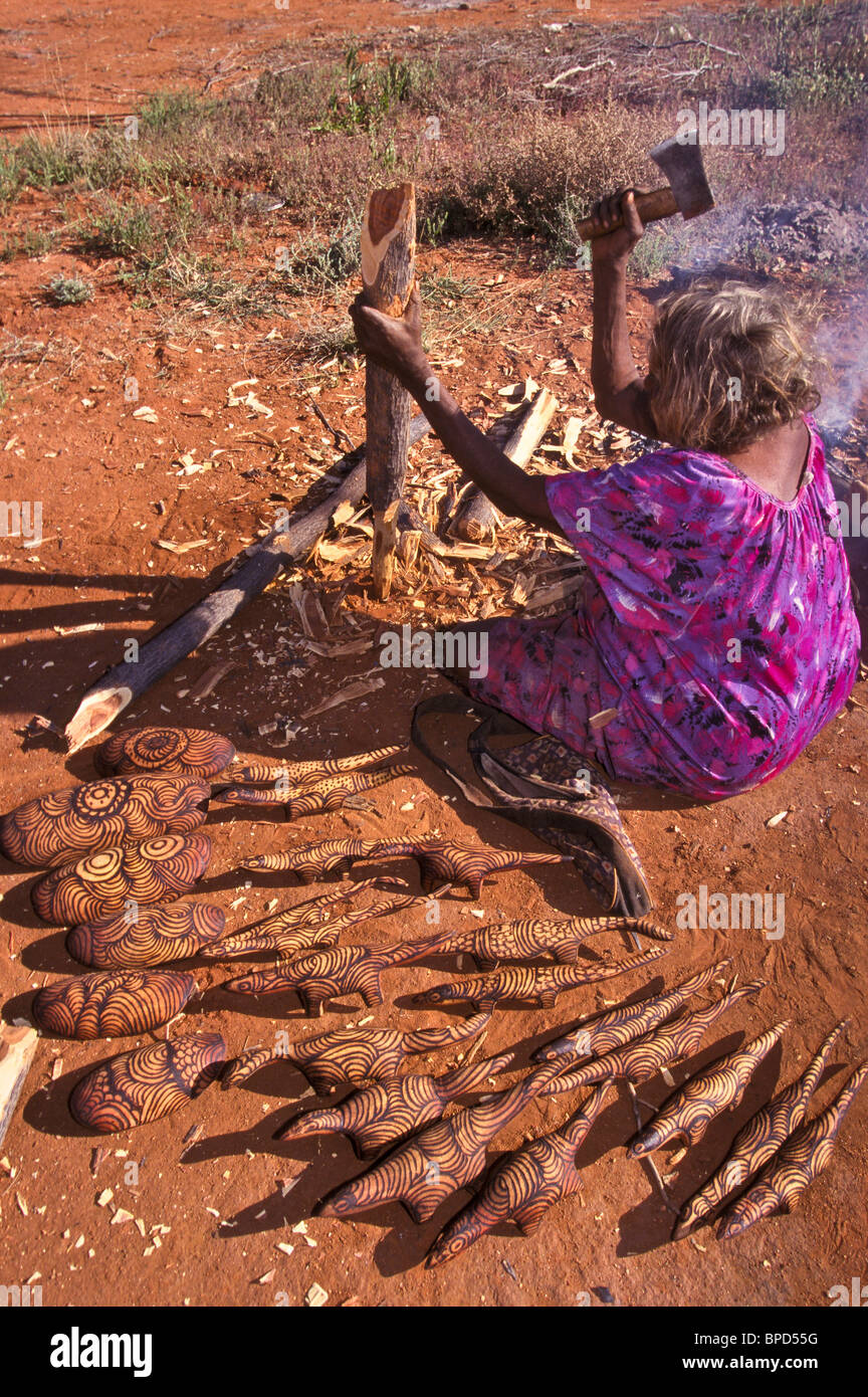 Senior Anangu woman preparing wood for carving, South Australia Stock ...