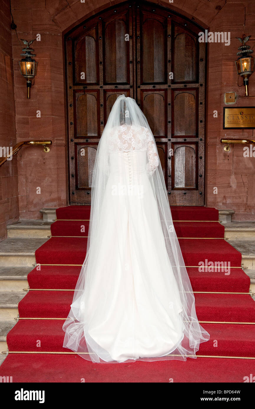 Bride standing on steps showing the back of her wedding dress Stock ...