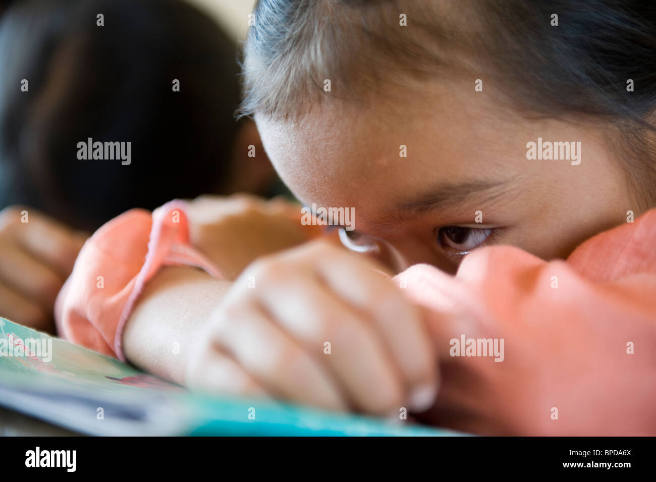 Peeping. A young girl in a Vietnamese classroom spies on whats ...