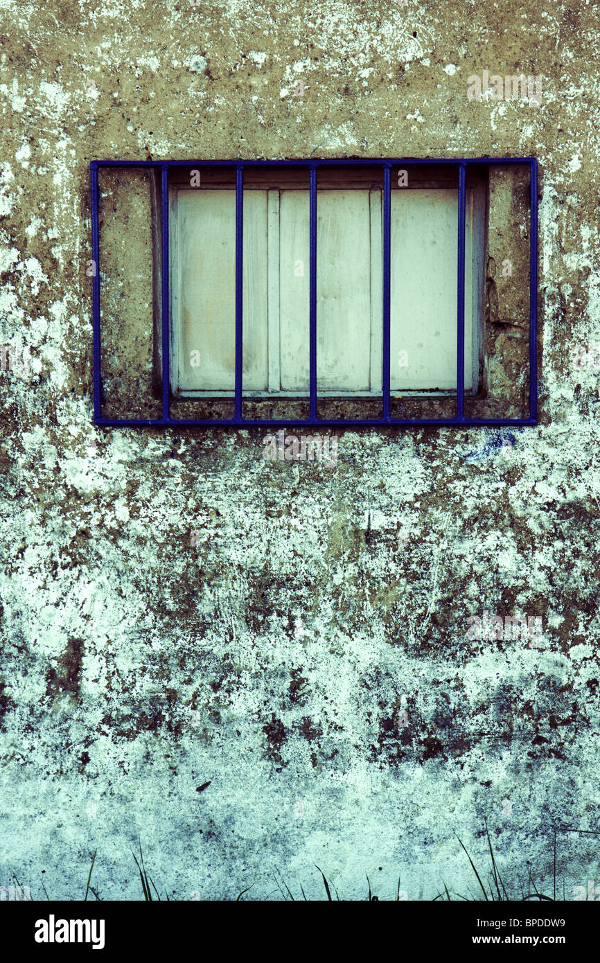 Barred window in gray wall Stock Photo - Alamy