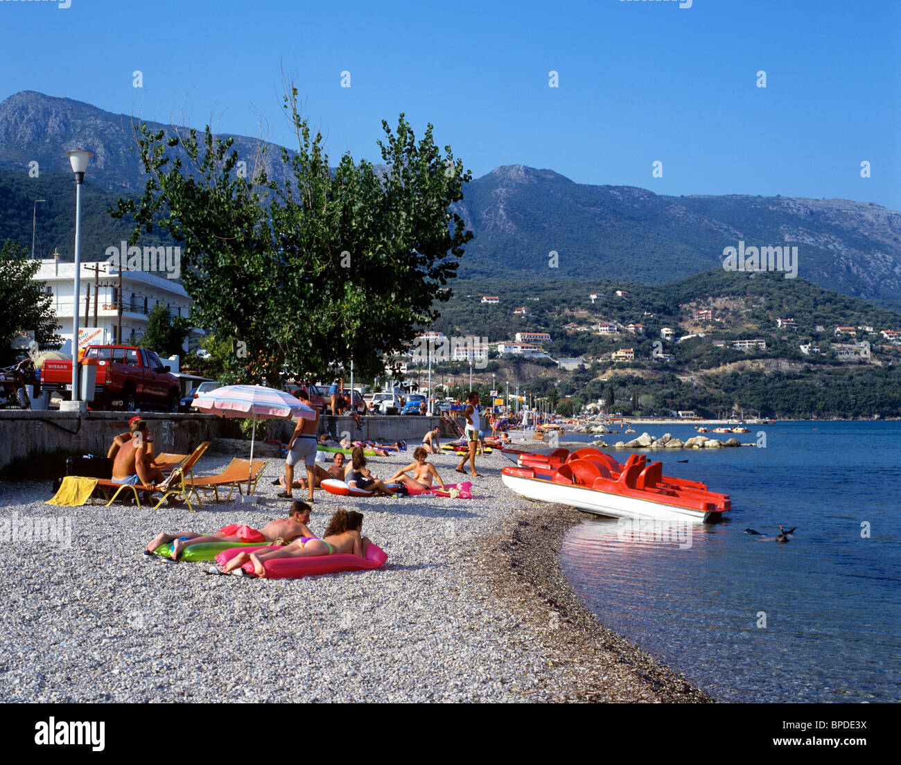 Beach scene at the popular Corfu resort of Ipsos Stock Photo - Alamy