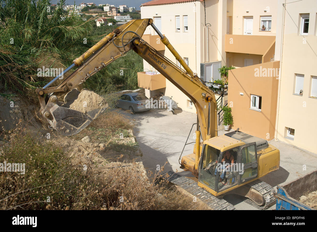 Mechanical digger removing earth from embankment Crete Greece Stock ...