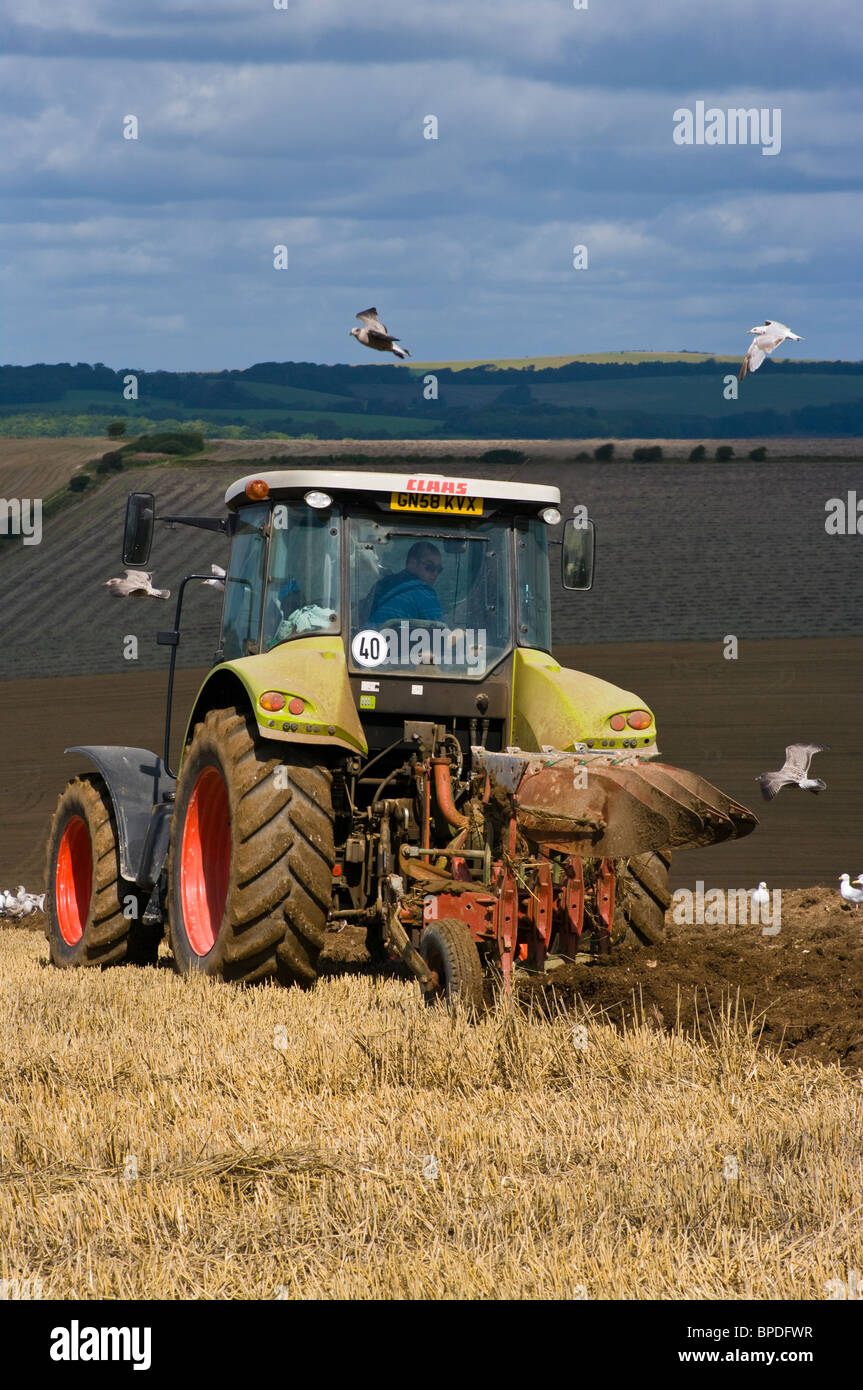 A Plough On The Back Of A Tractor Ploughing A Field Stock Photo - Alamy
