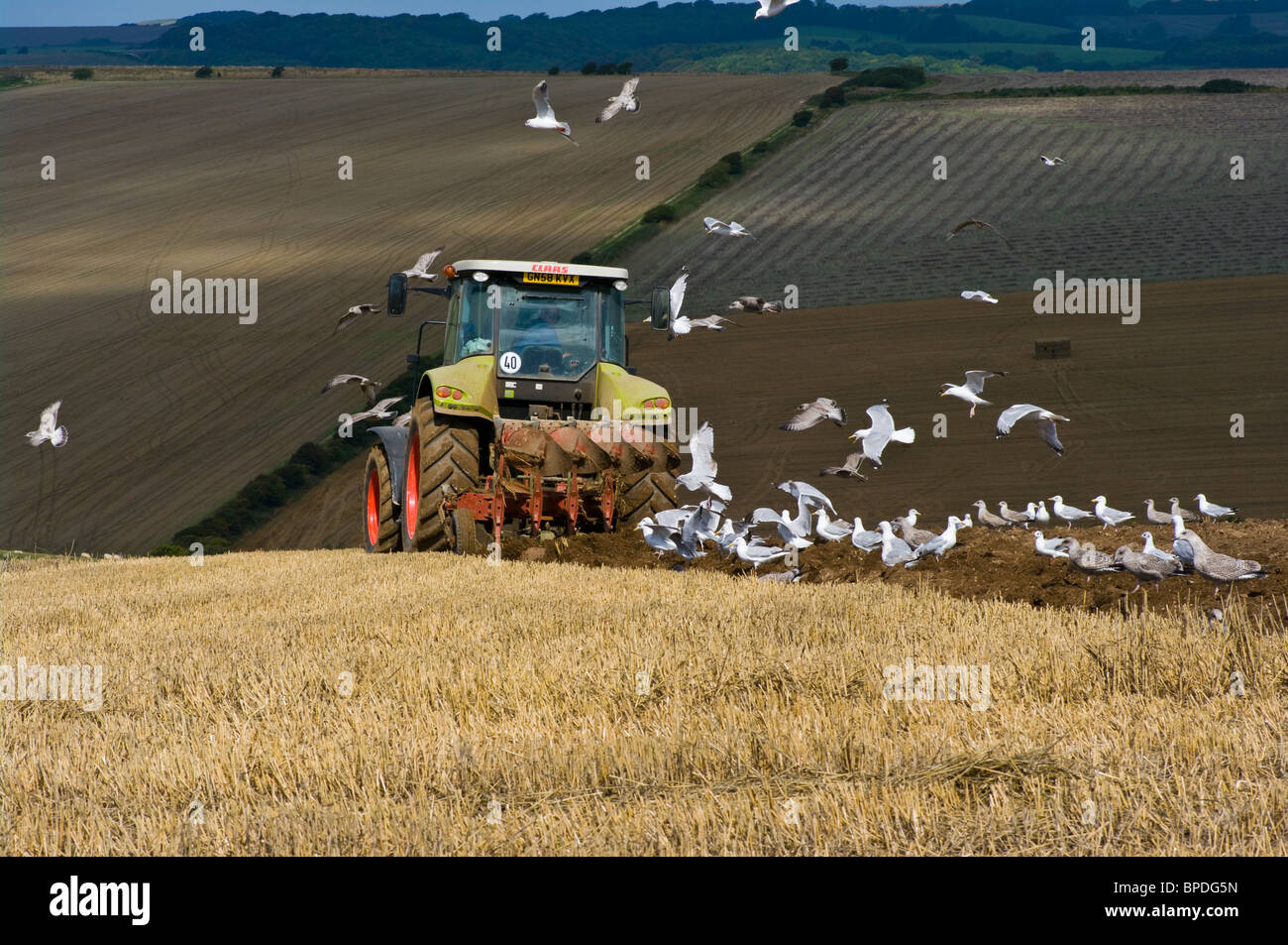 A Plough On The Back Of A Tractor Ploughing A Field Stock Photo - Alamy
