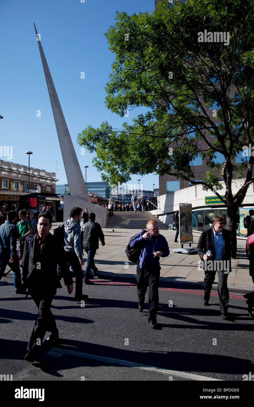 Commuters walking past the spike sculpture towards London Bridge a the ...