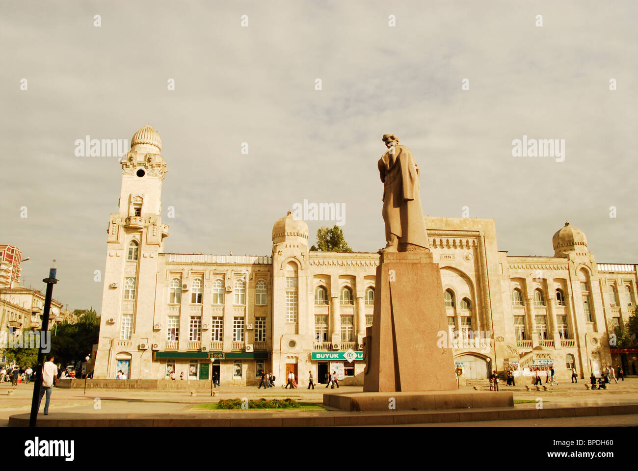 Baku, Azerbaijan, White old soviet era building and a statue to Baku ...