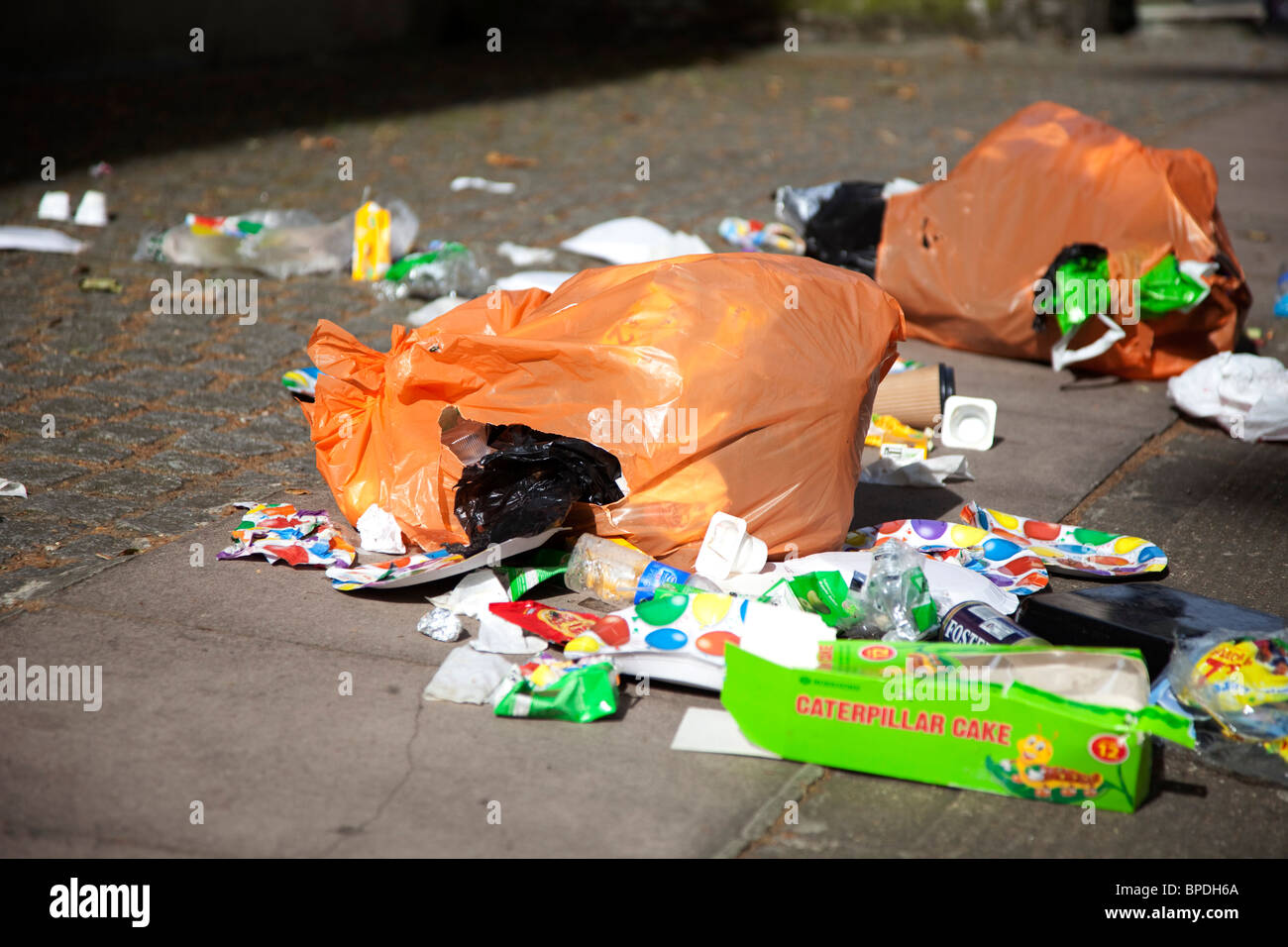 Rubbish on the street. Litter on a large scale next to a bin Stock ...