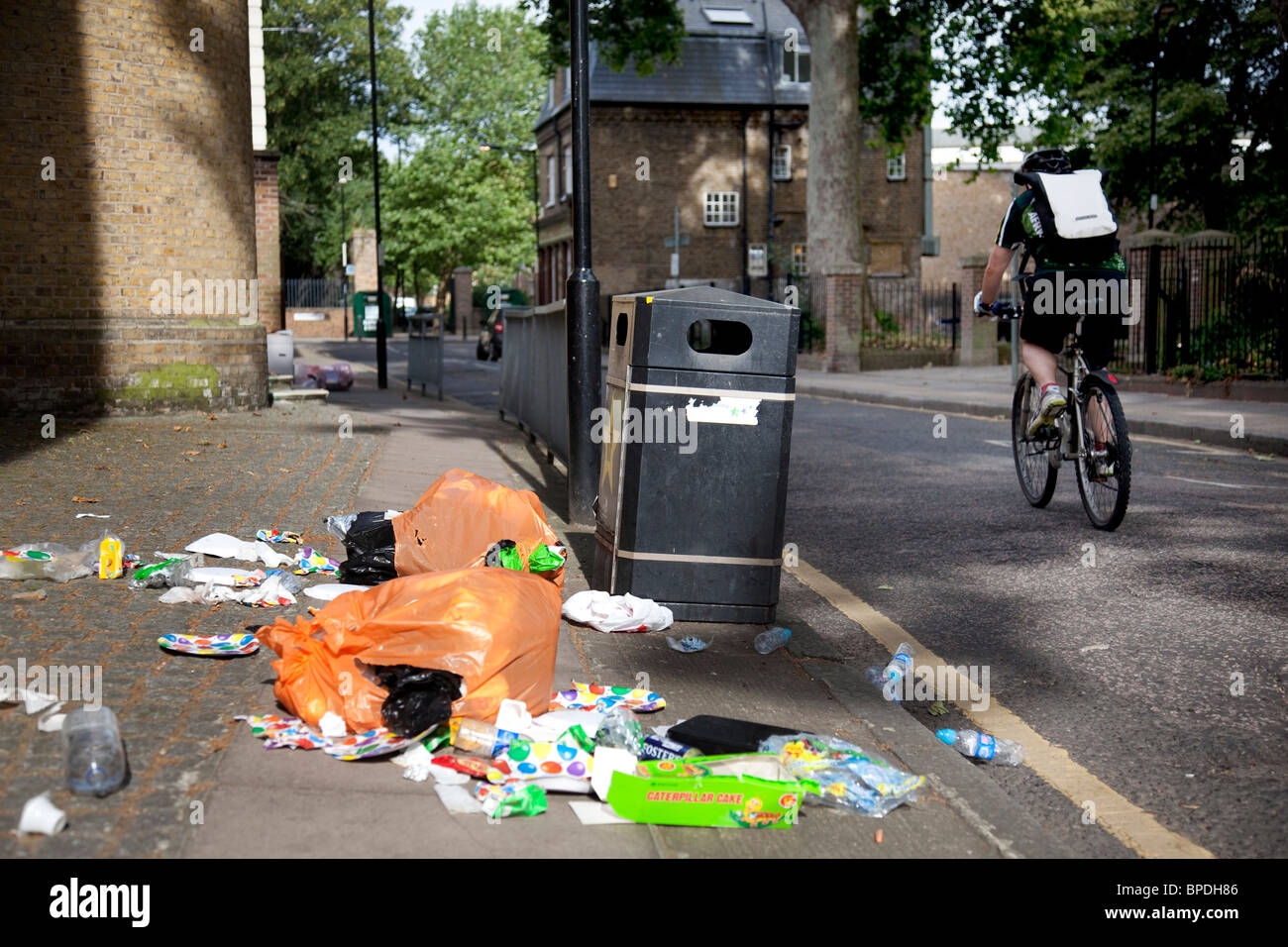 Rubbish on the street. Litter on a large scale next to a bin Stock ...