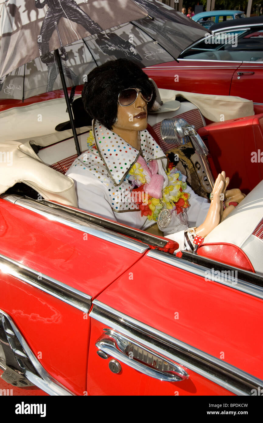 Elvis puppet in the back of a red Chevrolet Impala during a vintage car ...
