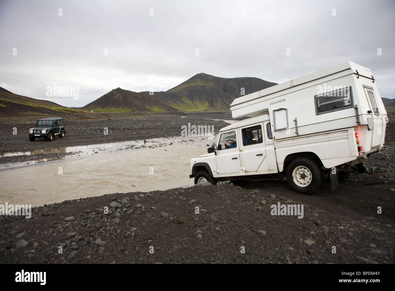 2 Land Rovers fording a river in the interior Highlands of Iceland ...