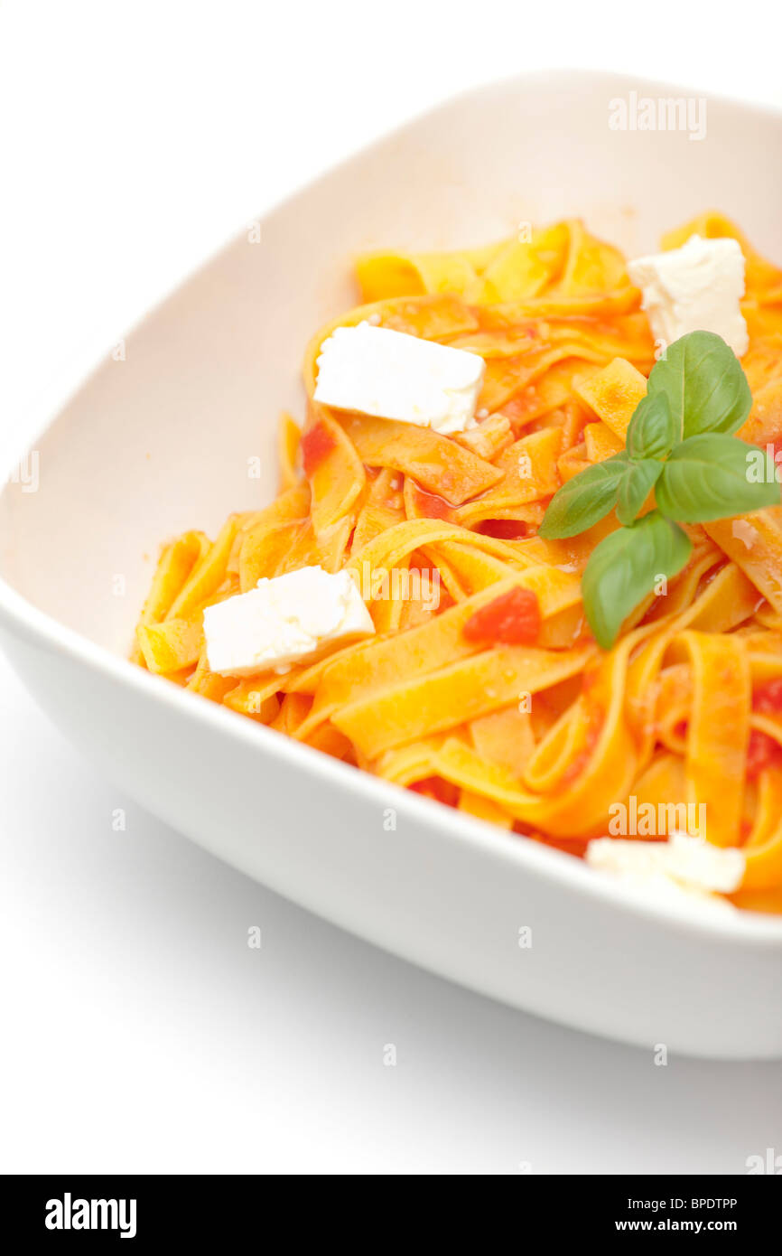 Tagliatelle pasta with tomato sauce and basil in a white bowl Stock ...