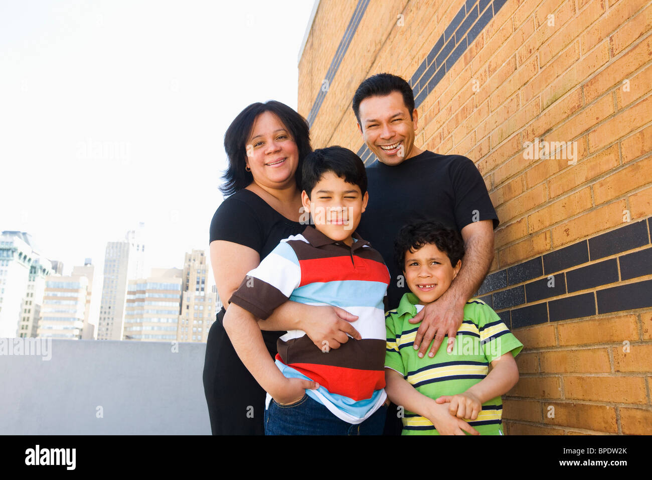 Hispanic family hugging outdoors Stock Photo - Alamy