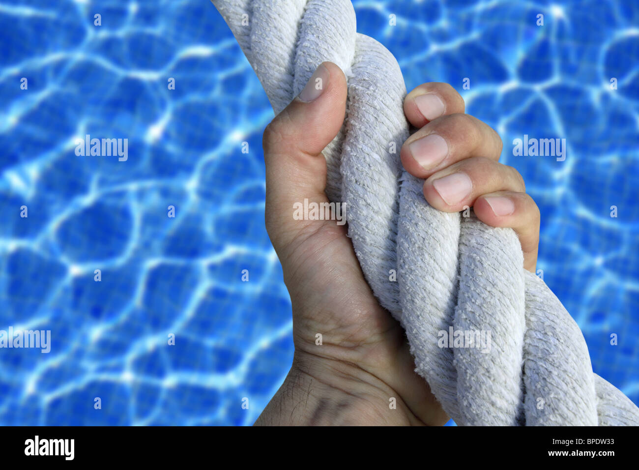 man hand grab grip adventure sport blue pool big rope Stock Photo - Alamy