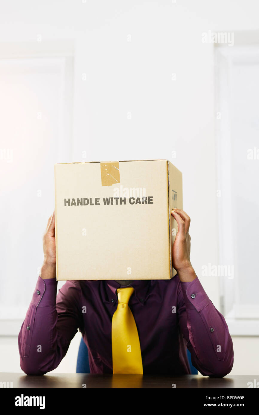 Black businessman with box over his head Stock Photo - Alamy