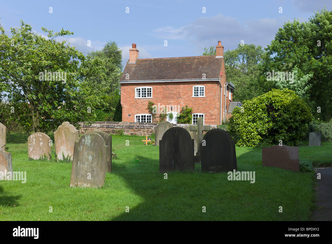 gravestones lit by the sun in a country cemetery Stock Photo - Alamy