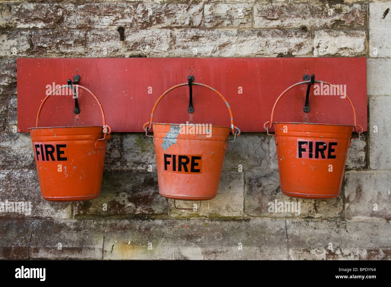 A row of three red fire buckets at Corfe Castle railway station, Dorset ...