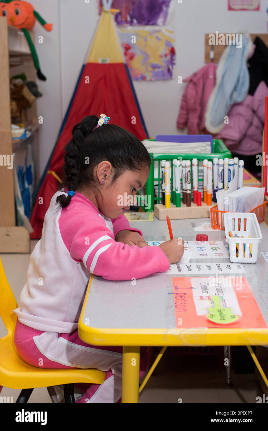 4 year old preschool girl writing a letter in her classroom Stock Photo ...