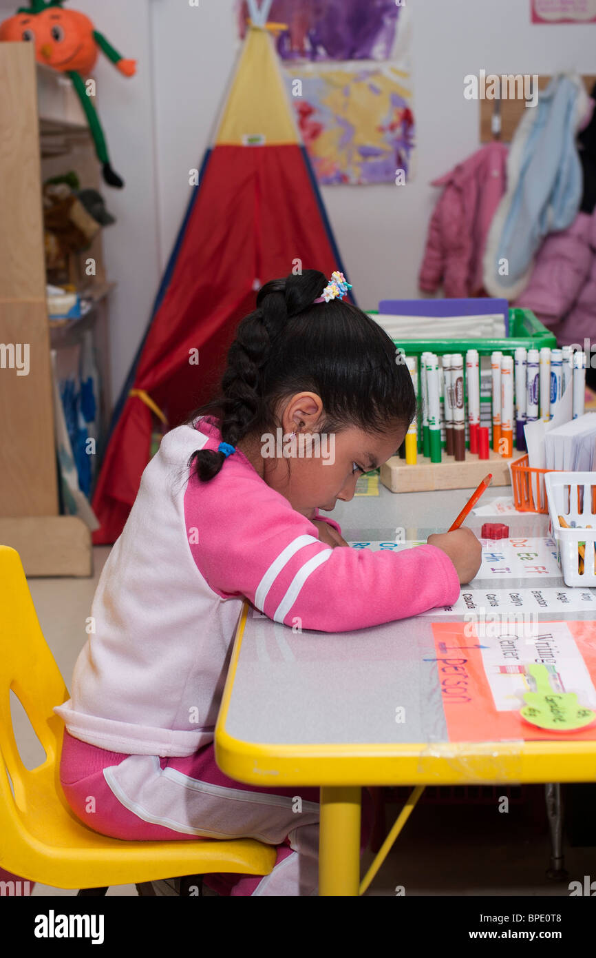 4 year old preschool girl writing a letter in her classroom Stock Photo ...