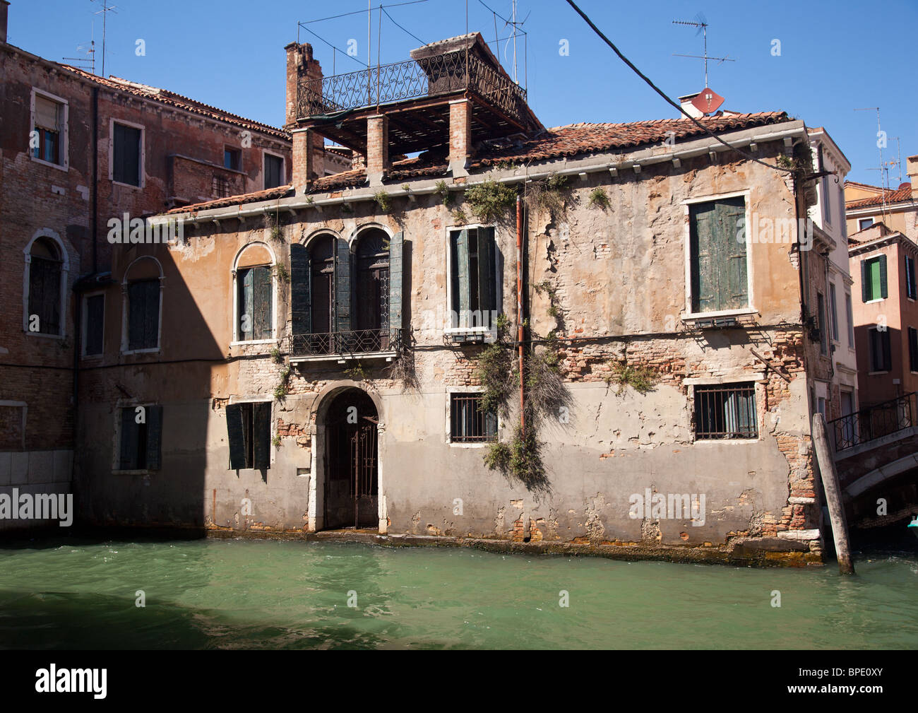 Backwater in Venice showing small canal and old building Stock Photo ...