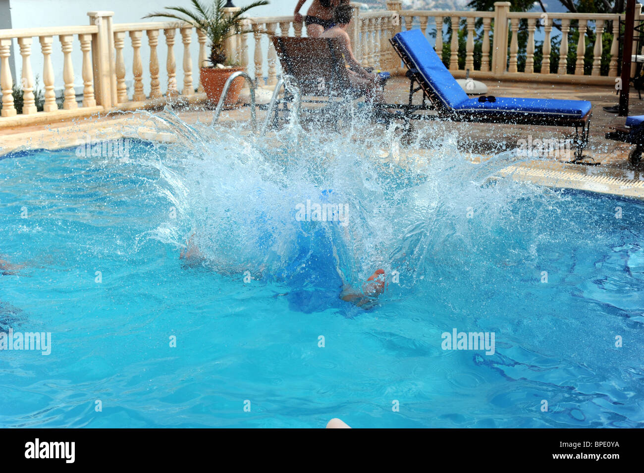 A man makes a huge splash as he jumps into the holiday villa swimming ...