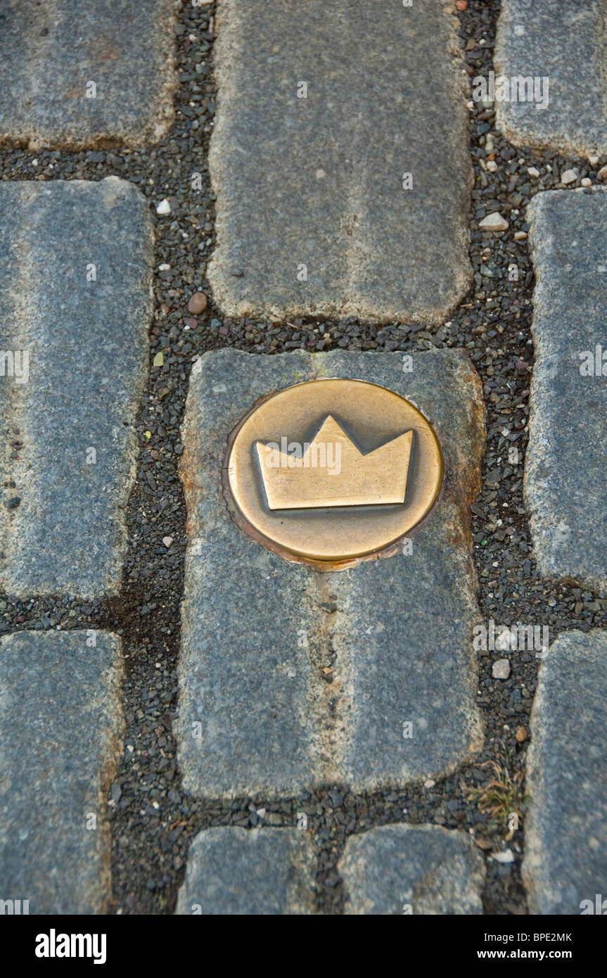 Slovakia, Bratislava. Brass crown marker in cobblestone streets show ...